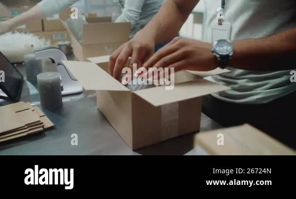 Close Up of Diverse Postal Workers, Shipping Clerks Packing Cardboard ...