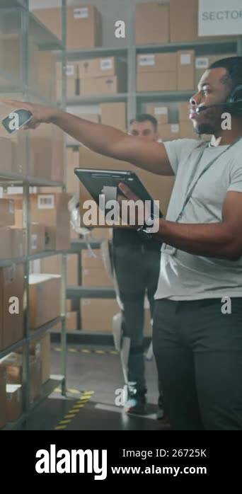 High-Tech Warehouse: Worker in Futuristic Full Body Robotic Exoskeleton ...