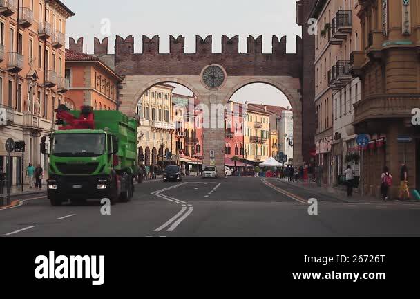 Verona, Italy 1 January 2025: Vehicles navigating beneath ancient gate ...