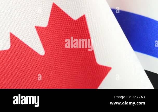 The Canadian and Israeli flags rotating together against a black ...
