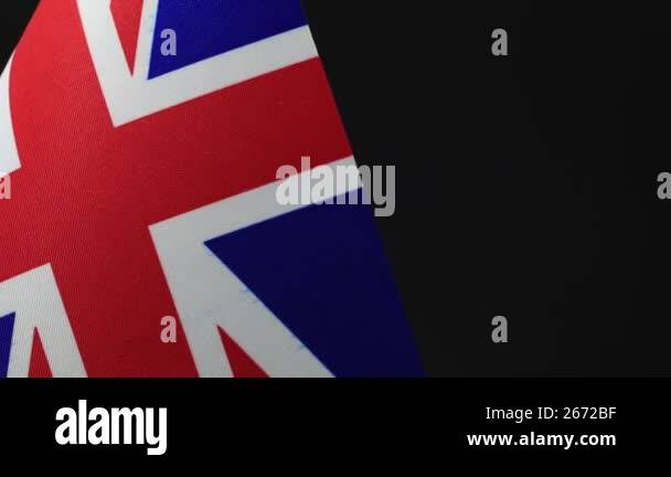 The Union Jack flag spinning, showing its red, white, and blue pattern ...