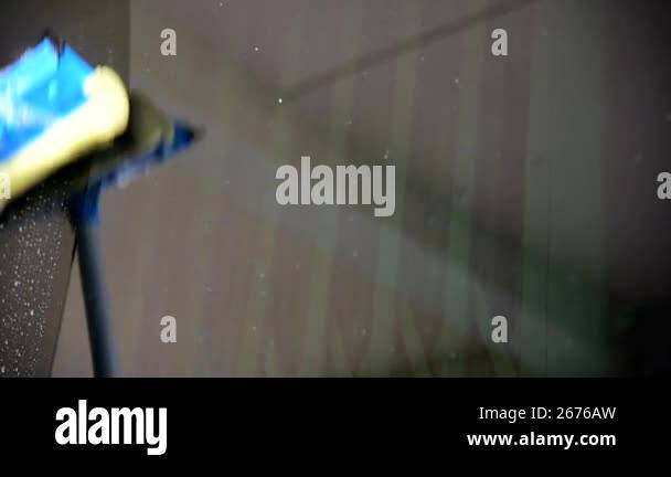 The man use squeegee to cleaning the glass of building Stock Video ...