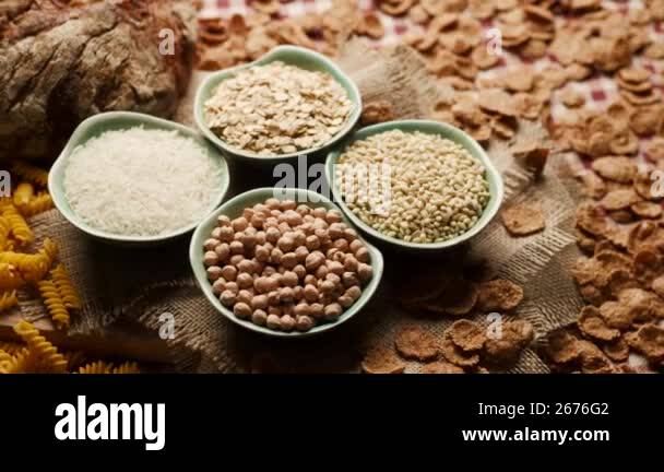 Close-up of assorted carbohydrate-rich foods arranged on a table ...