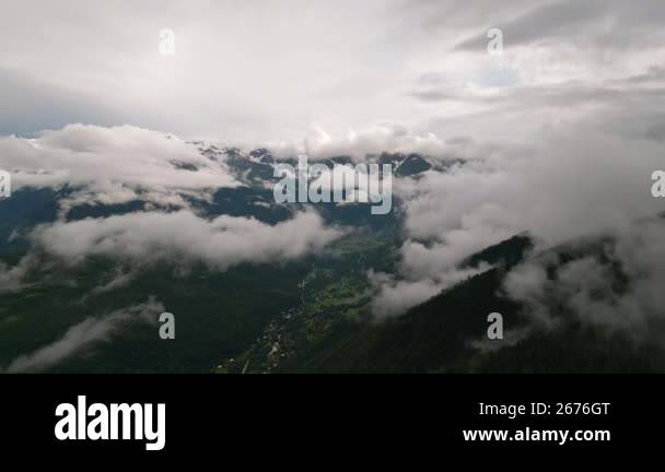 Aerial view of Mazeri village mountains in Svaneti with clouds drifting ...
