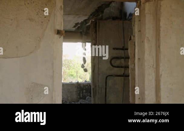 Rusty pipes visible among demolished concrete walls, empty evacuated ...
