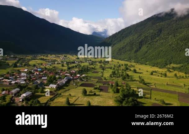 Aerial view sunrise Mazeri village mountains Svaneti. Green valleys ...