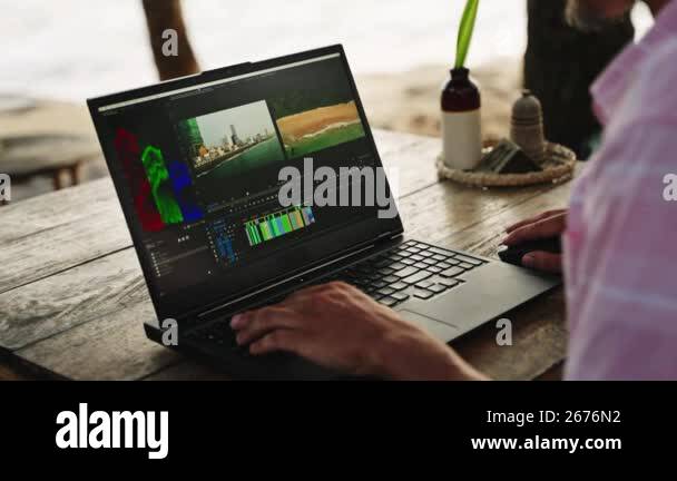 Freelancer color grades scenic ocean clips, enjoys tropical workspace ...