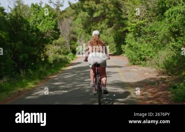 Eco-friendly travel, summertime outdoor activity. Active woman cycles ...
