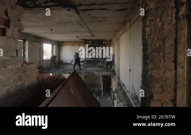 Men use jackhammers in burnt building for reconstruction. Workers ...