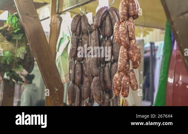 Rovigo, Italy 1 January 2025: Butcher wearing a mask preparing a cooked ...