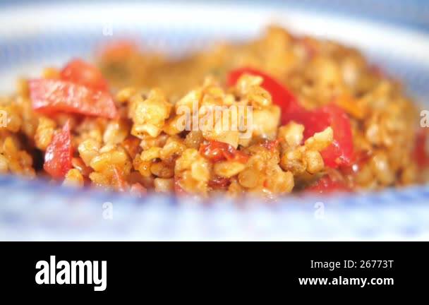 bulgur rice with tomato on a plate Stock Video Footage - Alamy