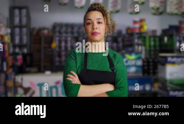 Professional female business owner in hardware store, arms crossed ...