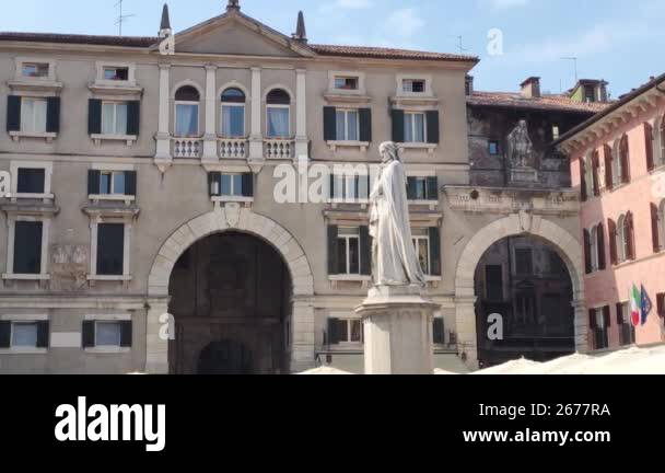 Verona, Italy 1 January 2025: Camera panning over a statue of dante ...