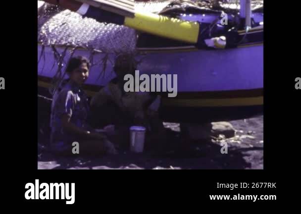 Denpasar, bali june 1985: two balinese fishermen repair their ...
