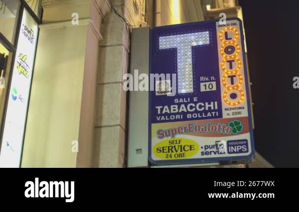 Rovigo, Italy 1 January 2025: Illuminated sign with the words tabacchi ...