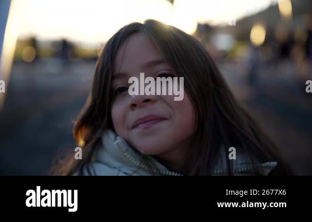 Joyful 8 year old little girl close-up face at playground park during ...