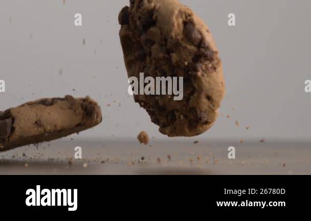 Chocolate Chip cookies falling into table surface capturing the impact ...