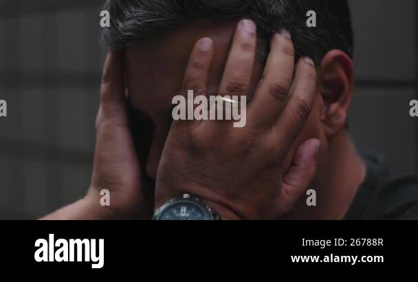 Man covering face and holding head with hands, overwhelmed by despair ...