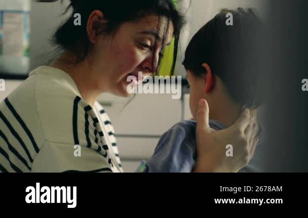 Touching moment unfolds as a caring mother embraces her tearful son in ...