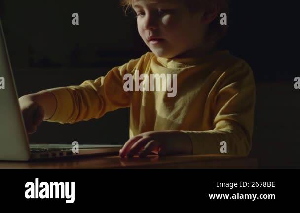 Baby with laptop. Blond baby working with laptop at home. Smart little ...