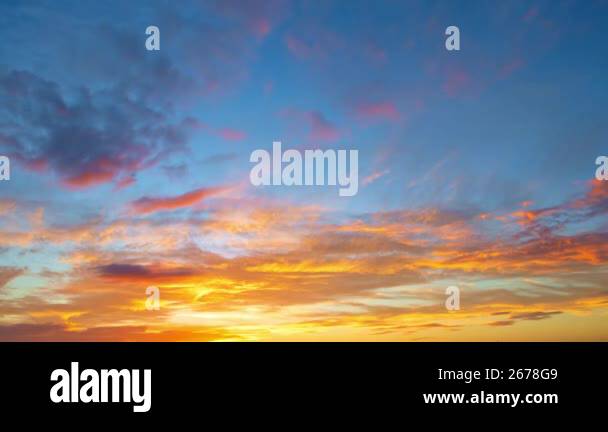 Timelapse Sunset with sun and clouds on blue and orange dramatic sky ...