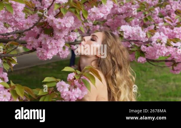 Beauty Woman on spring blossom field. Happy woman is resting in the ...