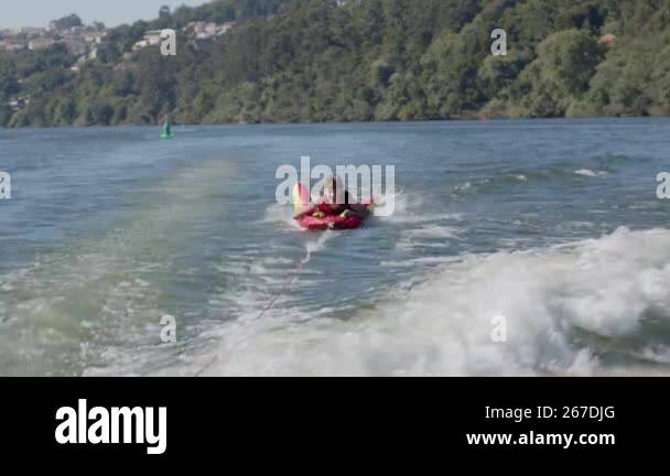 Boy wakesurfing on river, experiencing summer adventure with energetic ...