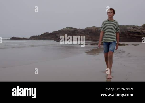 Sandy shoreline revealing teenage freedom, barefoot wandering along ...