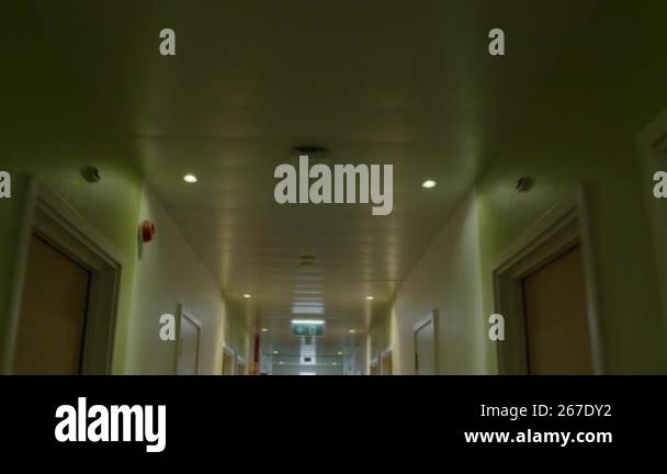 Emergency lighting activating progressively along darkened building ...