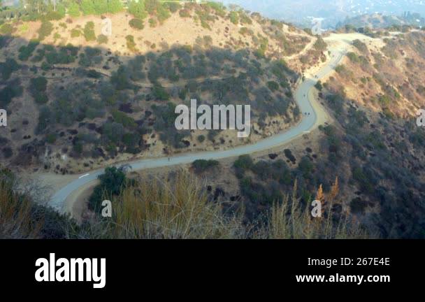 Aerial perspective of a winding road in Runyon Canyon Park, with hikers ...