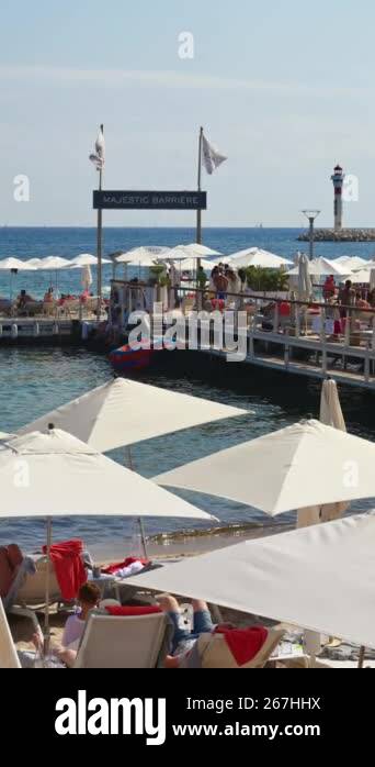 Cannes, France - October 15, 2024: People relaxing under umbrellas on ...