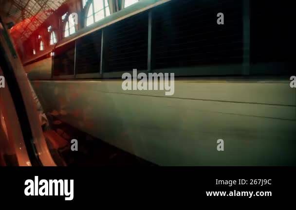 Close up view from a window of a train moving on the rails near a ...