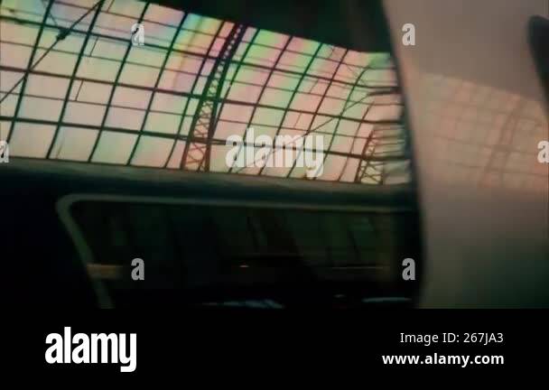 Close up view from a window of a train moving on the rails near a ...