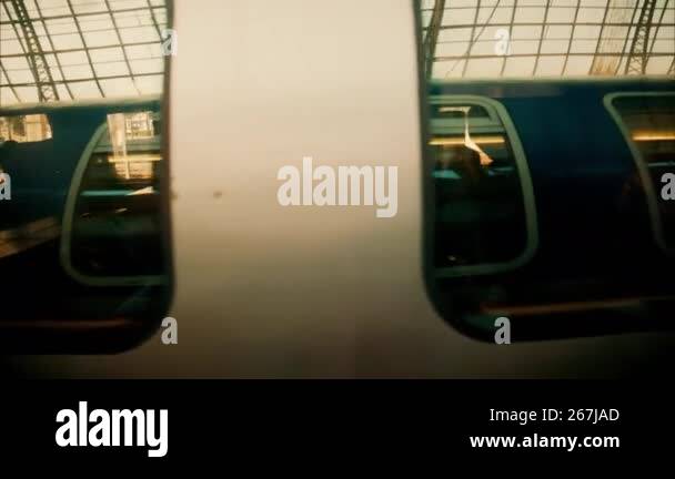 Close up view from a window of a train moving on the rails near a ...