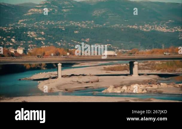 Distant view of cars moving on a bridge over the Var river in Nice ...