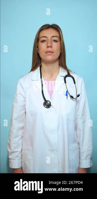 vertical Professional female doctor in white lab coat and stethoscope ...