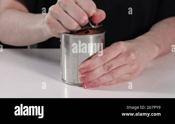 opening a can of caramelized condensed milk, showcasing preparation for ...