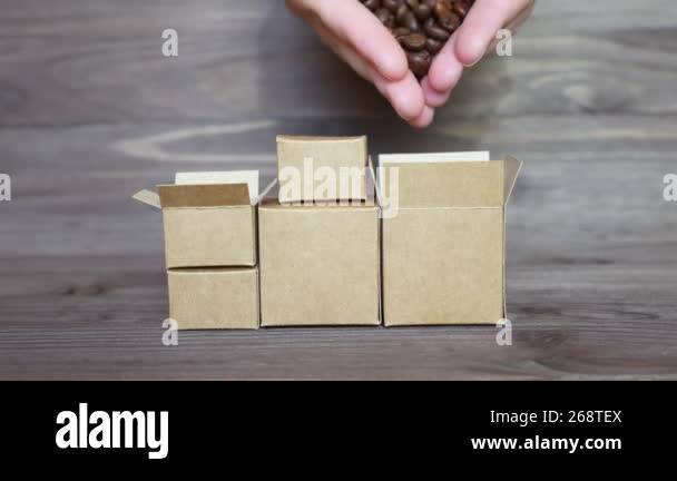 Arrangement of various cardboard boxes with roasted coffee beans being ...