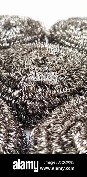 Stainless steel scrubber, metal pot sponge rotating on white background ...