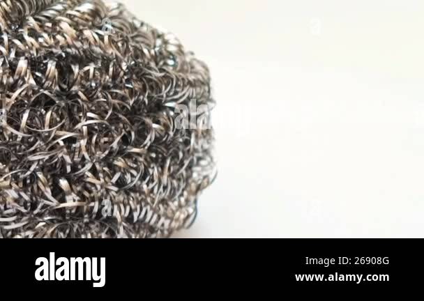 Stainless steel scrubber, metal pot sponge isolated rotating on white ...