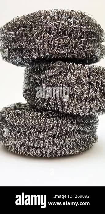Stainless steel scrubber, three metal pot sponge rotating on white ...