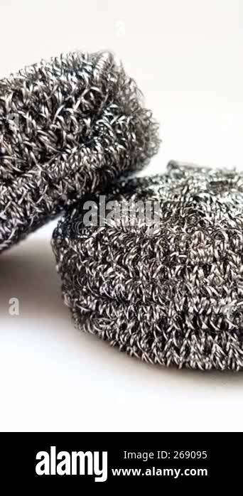 Stainless steel scrubber, two metal pot sponge rotating on white ...