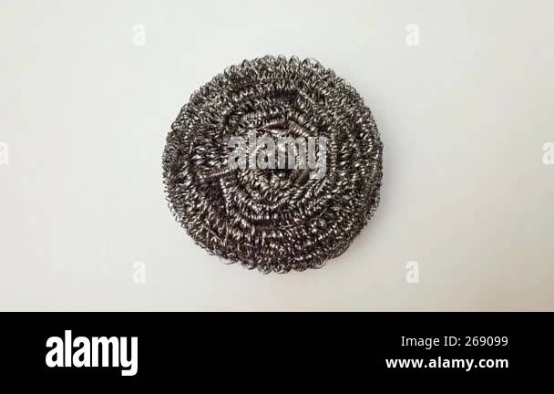 Stainless steel scrubber, metal pot sponge isolated rotating on white ...