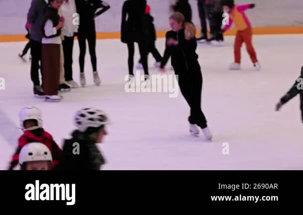 Group of figure skaters practicing together on ice rink during casual ...