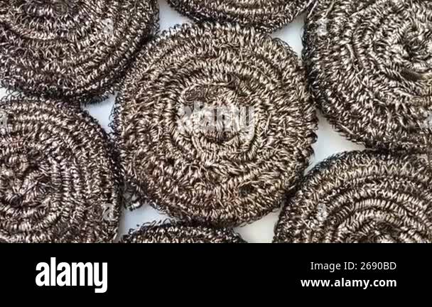 Stainless steel scrubber, metal pot sponge rotating background, close ...