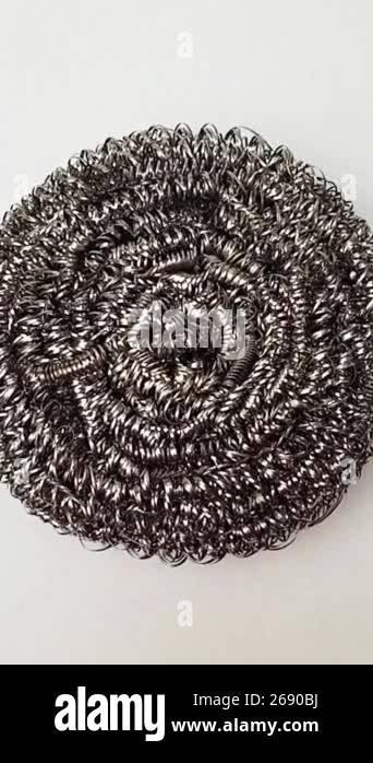 Stainless steel scrubber, metal pot sponge isolated rotating on white ...