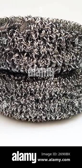 Stainless steel scrubber, two metal pot sponge rotating on white ...