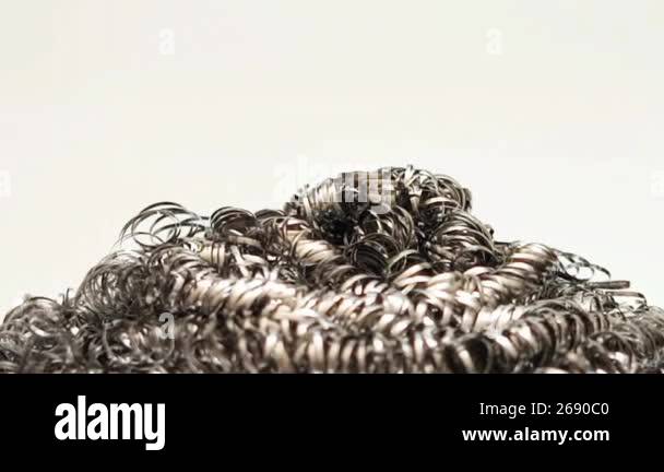 Stainless steel scrubber, metal pot sponge isolated rotating on white ...