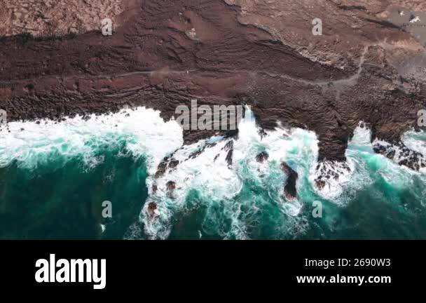 Top Drone view of witness the breathtaking views of waves crashing ...