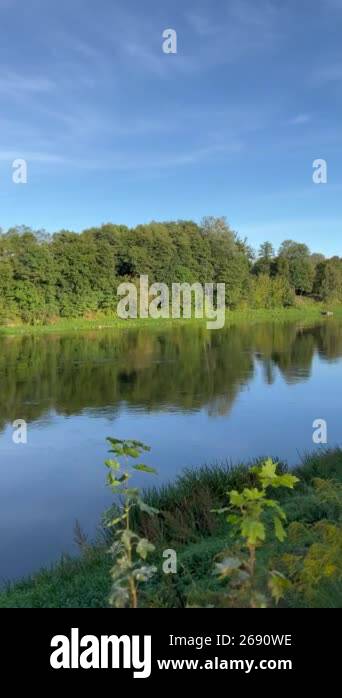 A serene video of the Neman River in Lithuania, surrounded by lush ...